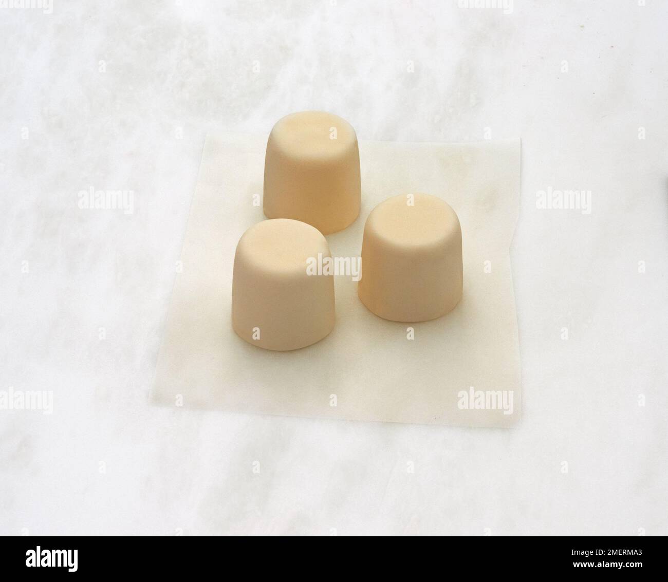 Three small cakes covered with white icing Stock Photo - Alamy
