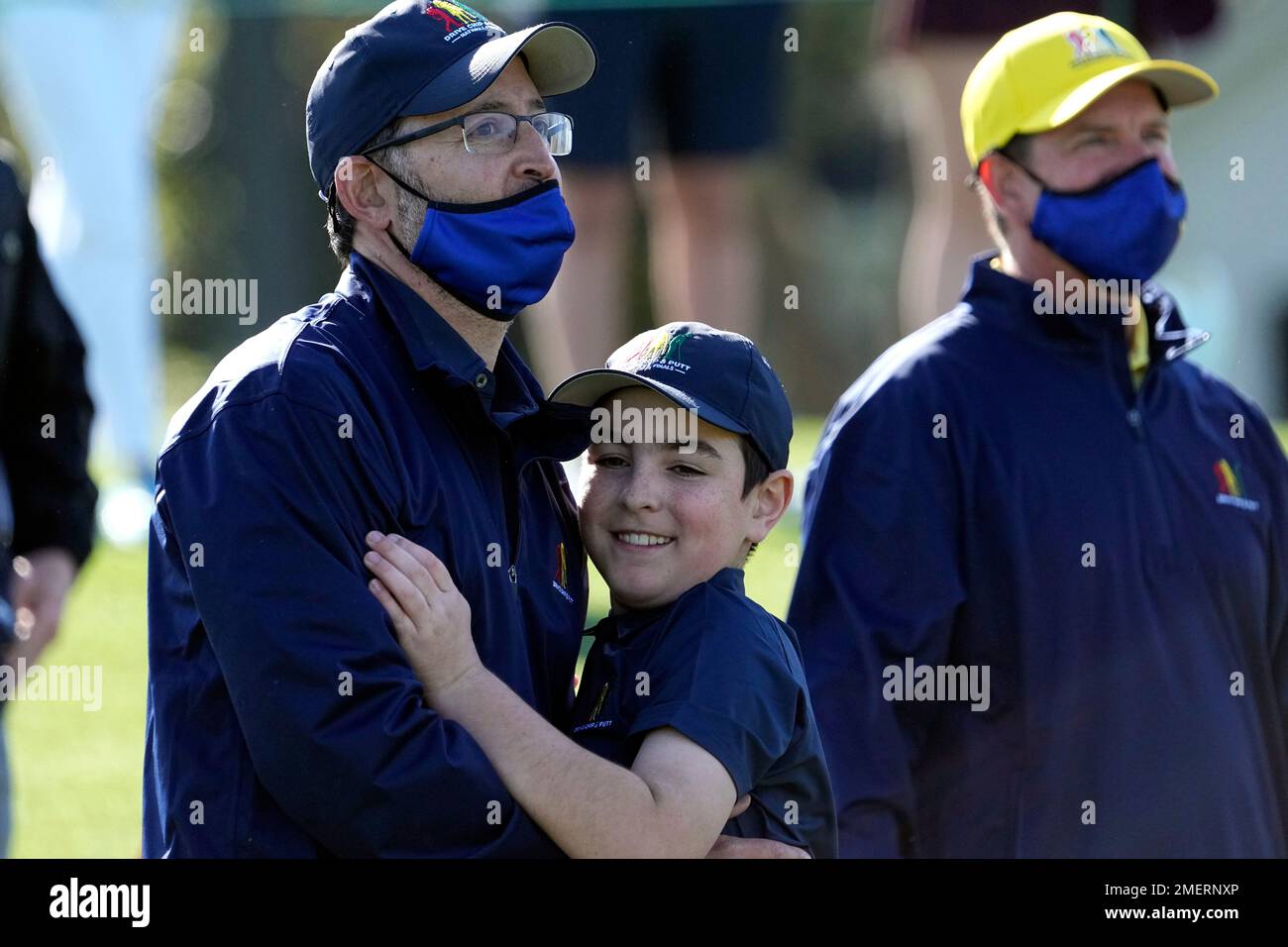 Lucas Bernstein, center, gets a hug from his dad, Michael, after ...