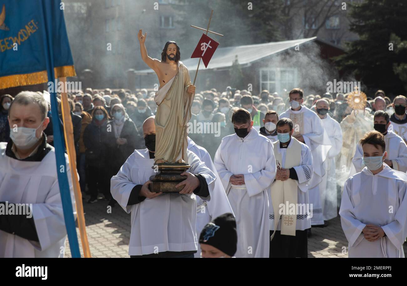 Catholic priest carries a statue of Jesus Christ as he walks in ...