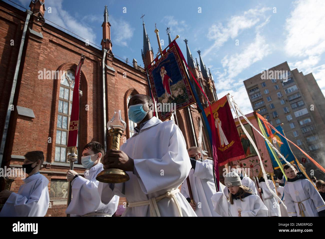 Catholic priests walk in a religious procession during the Easter ...
