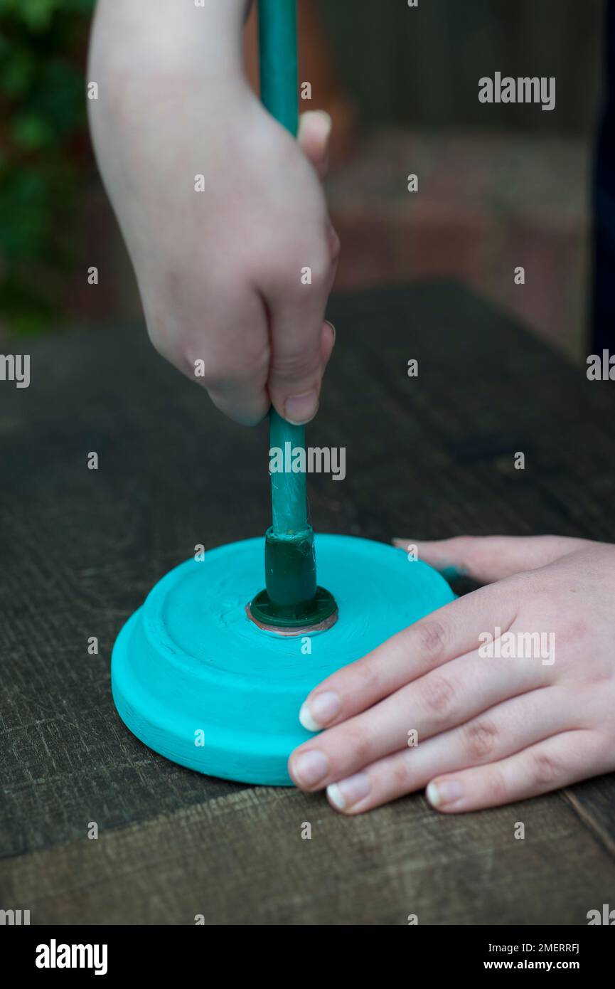 Fixing cane topper to bottom of saucer, to make a bird station Stock ...