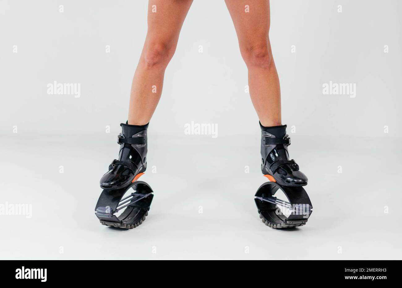 Fit female legs in jumping shoes on a white background Stock Photo - Alamy