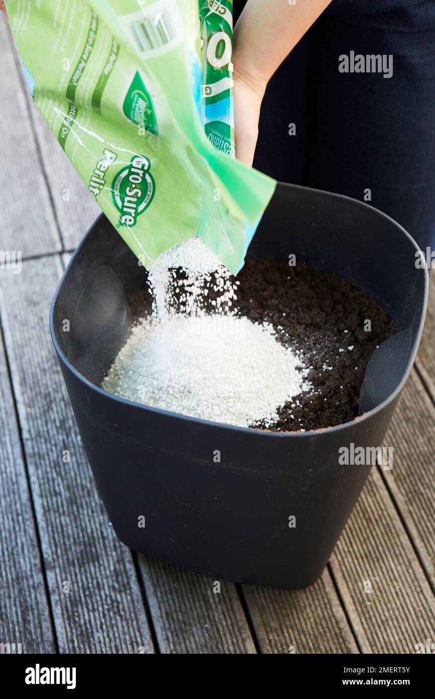 Mixing two types of compost in bucket Stock Photo - Alamy