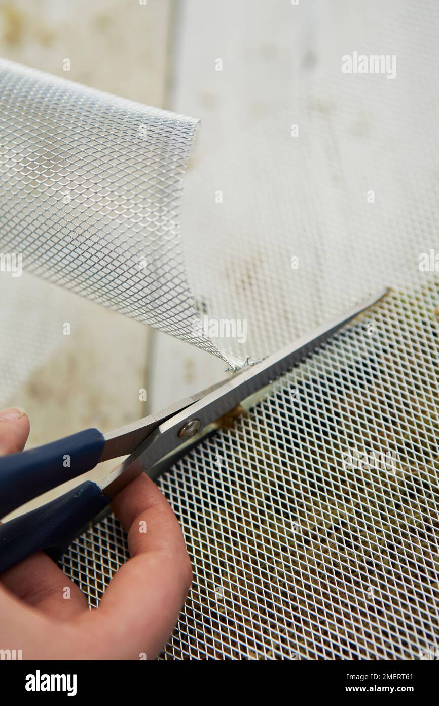Cutting micromesh to size over living picture frame Stock Photo - Alamy