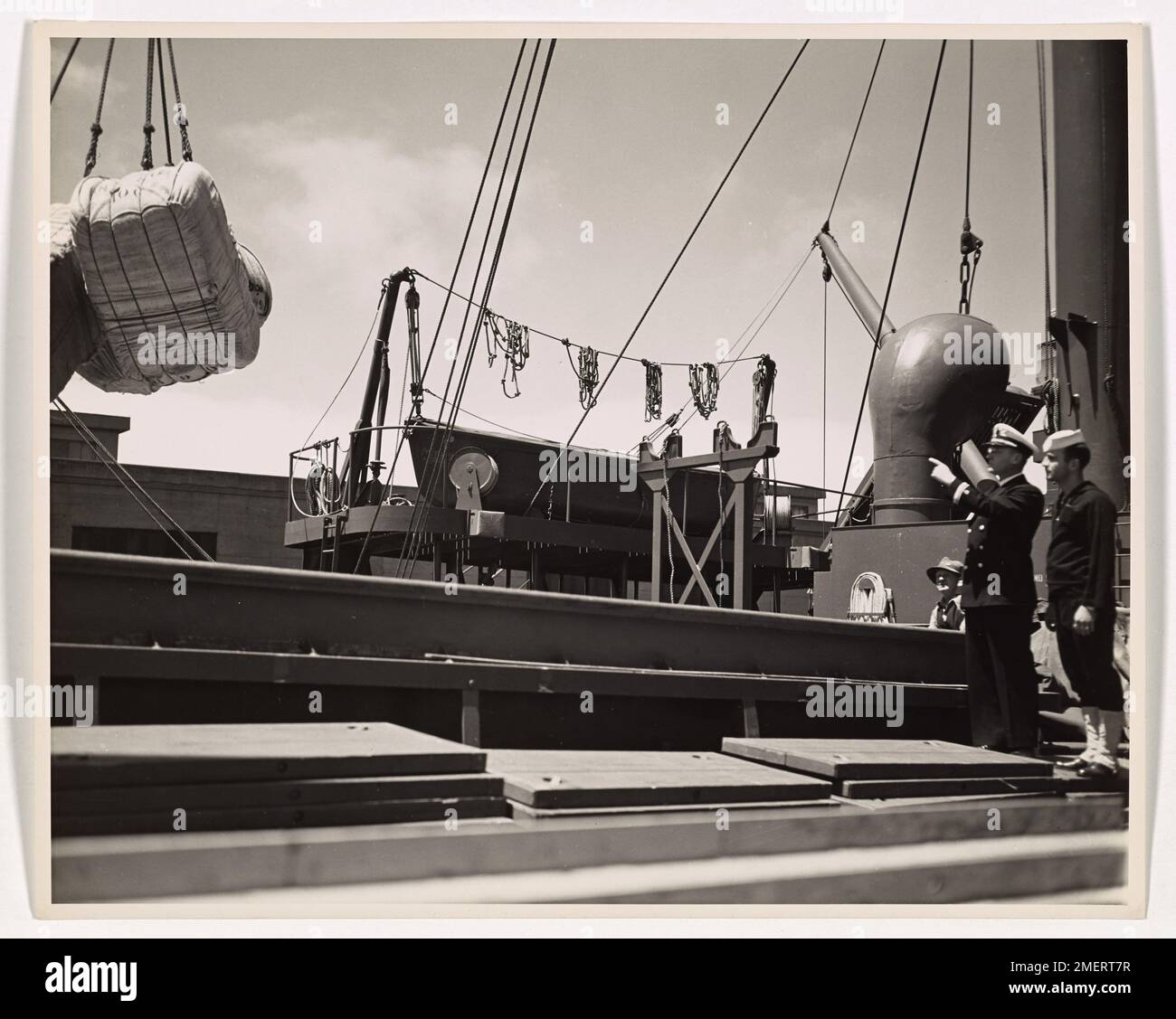 A photograph depicting a U.S. Coast Guard operation focused on port ...