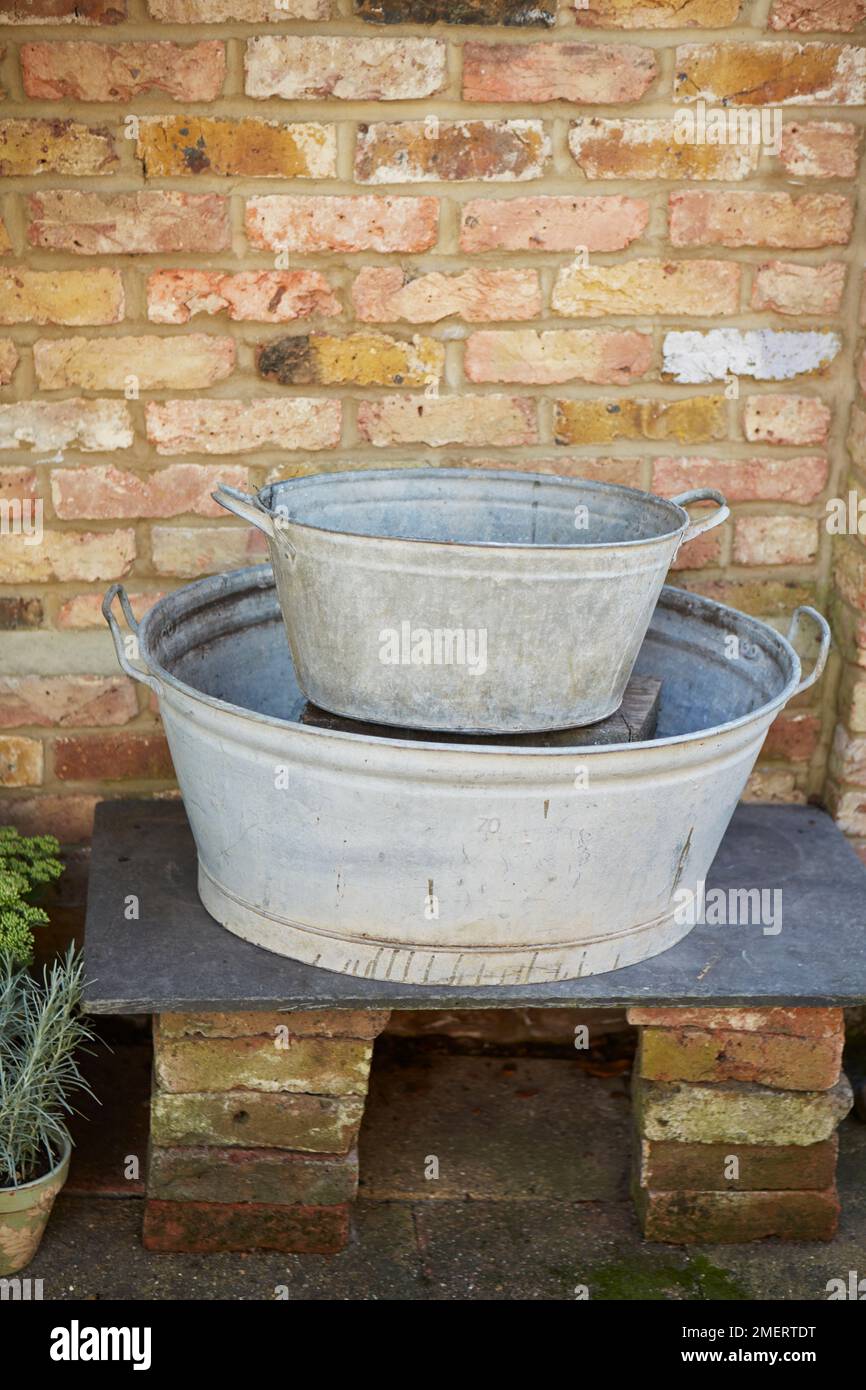 Small vintage galvanized steel bath on top of a large vintage ...