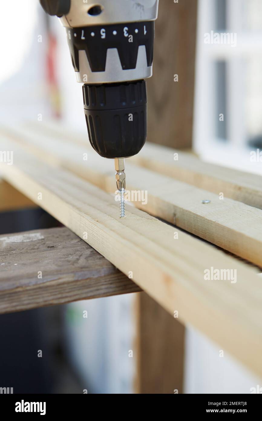 Securing shelves to step ladder planter Stock Photo - Alamy