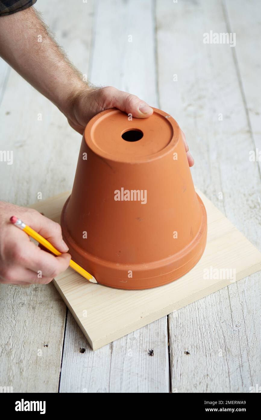 Making plant pot mobile, drawing outline around top edge of pot onto ...