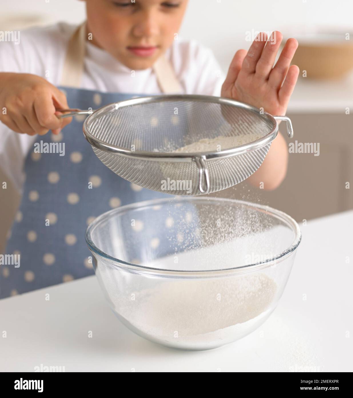 Boy sieving flour into bowl, 6 years Stock Photo - Alamy