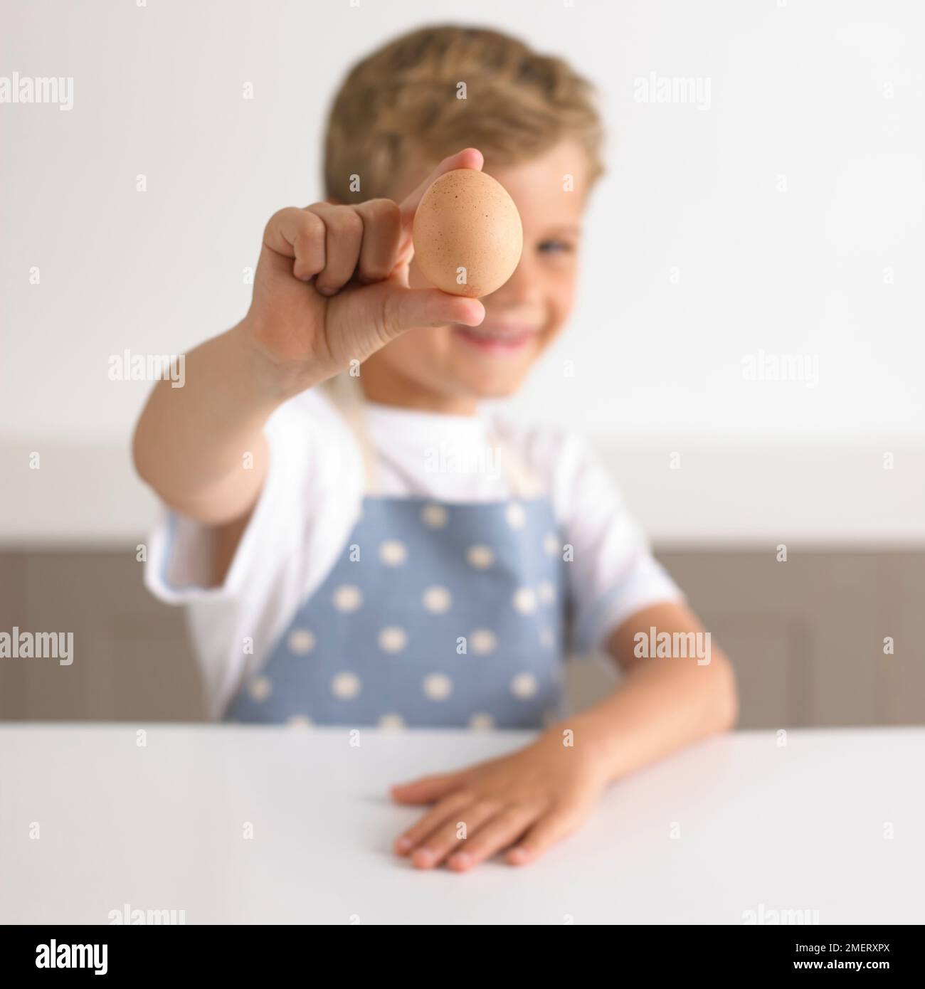 Boy holding an egg, 6 years Stock Photo - Alamy