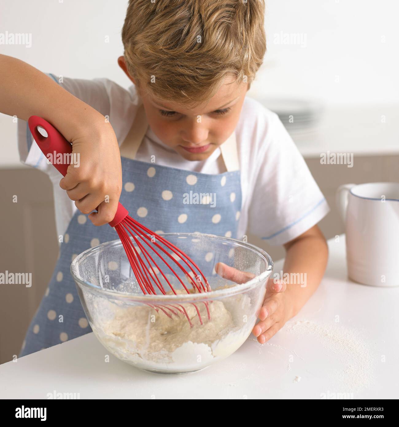 Boy whisking pancake batter in a bowl, 6 years Stock Photo - Alamy