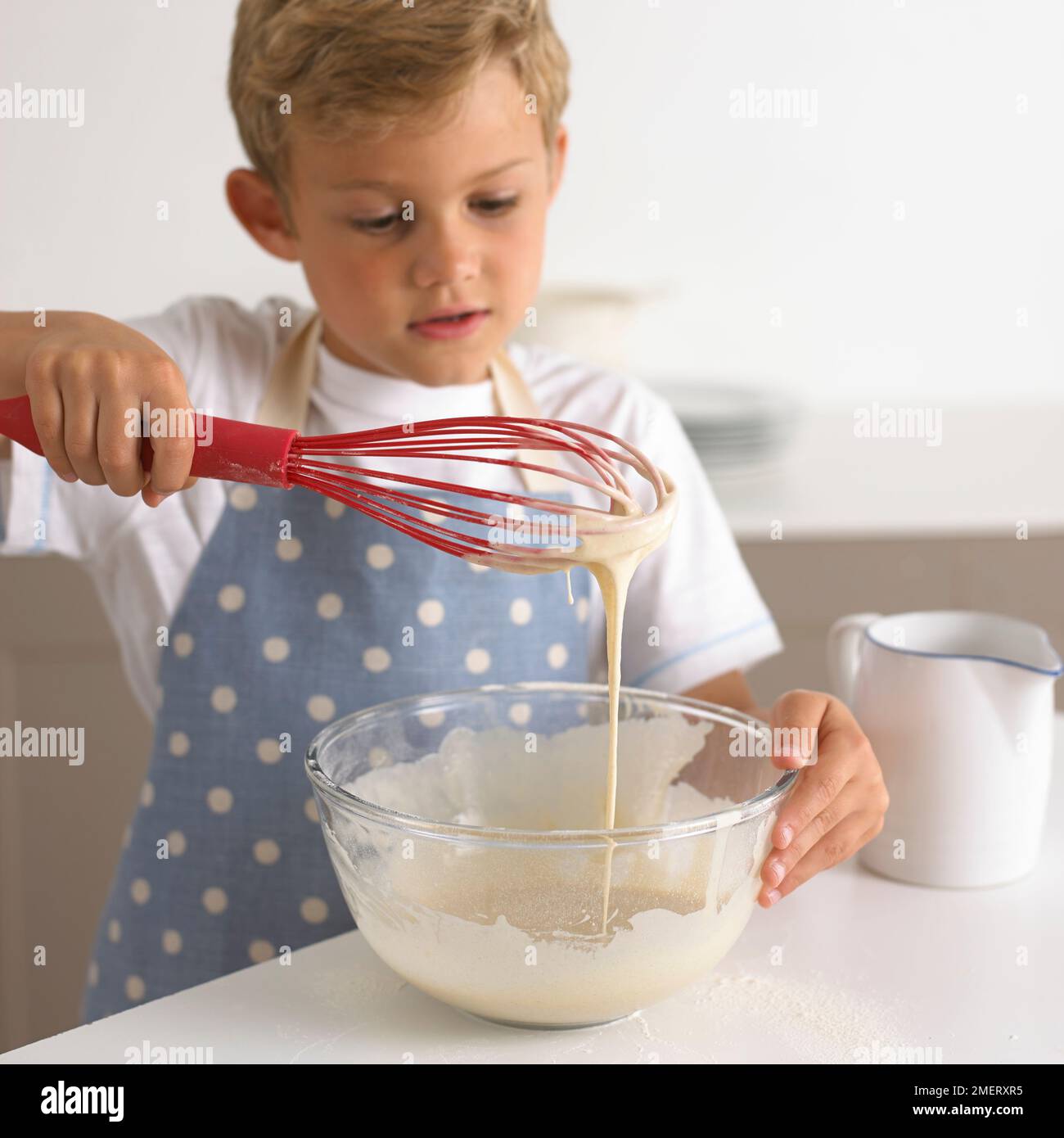 Boy whisking pancake batter in a bowl, 6 years Stock Photo - Alamy