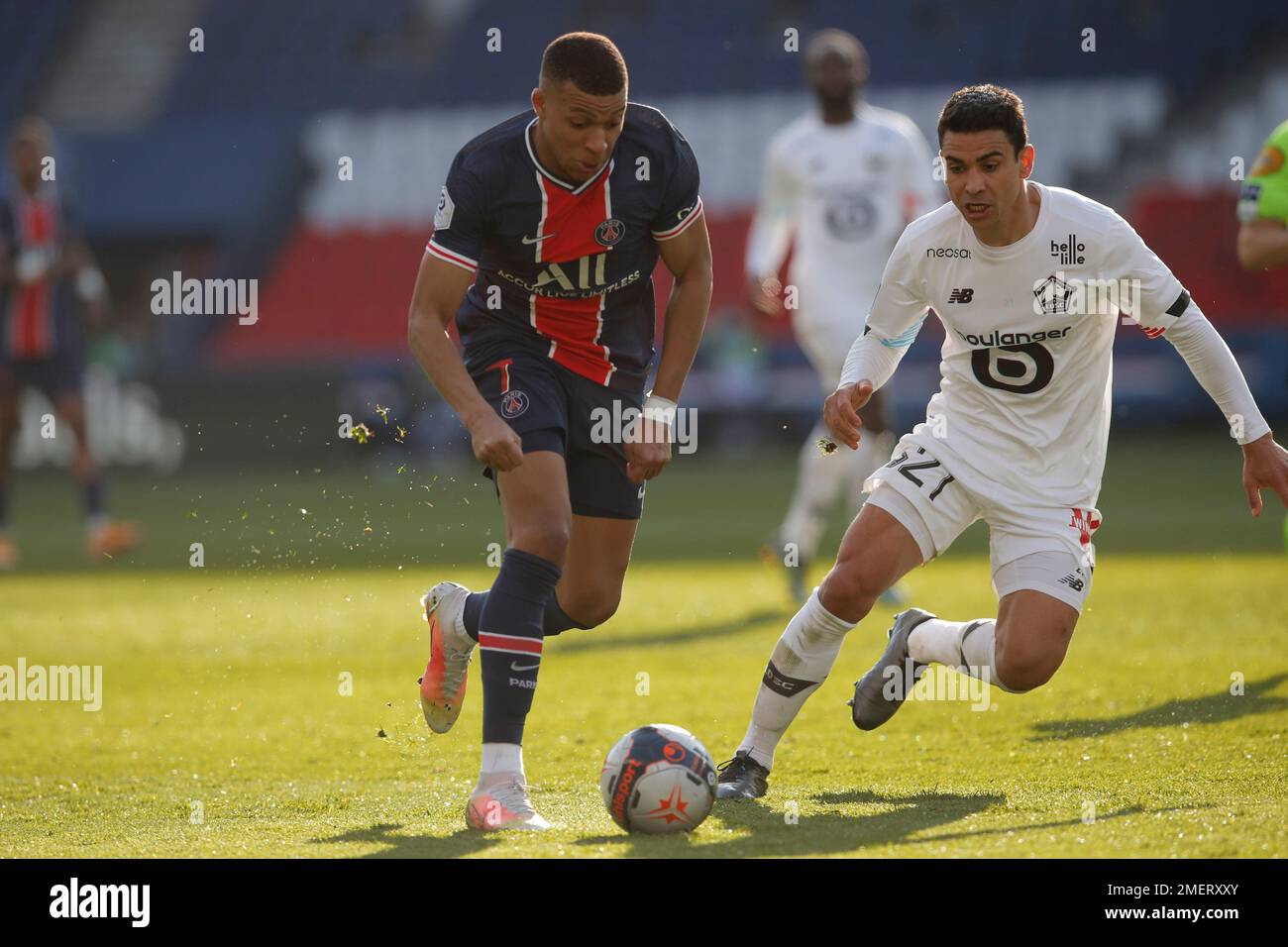 PSG's Kylian Mbappe, left, fights for the ball with Lille's Benjamin ...