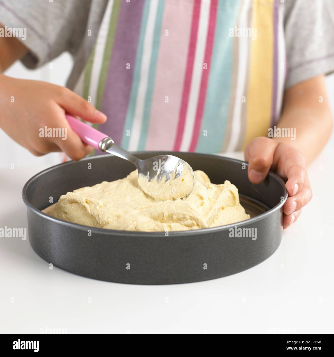Spreading sponge cake batter in a cake tin Stock Photo - Alamy