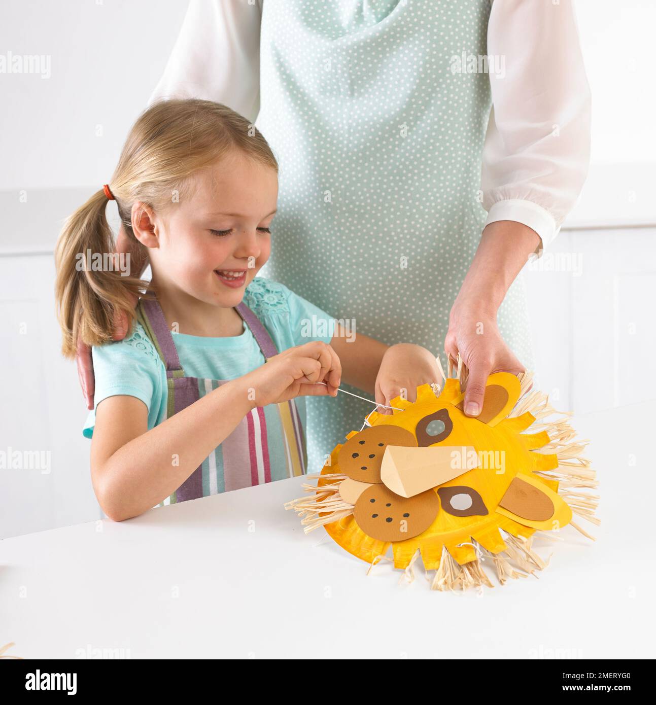 Girl making lion mask, 5 years Stock Photo - Alamy