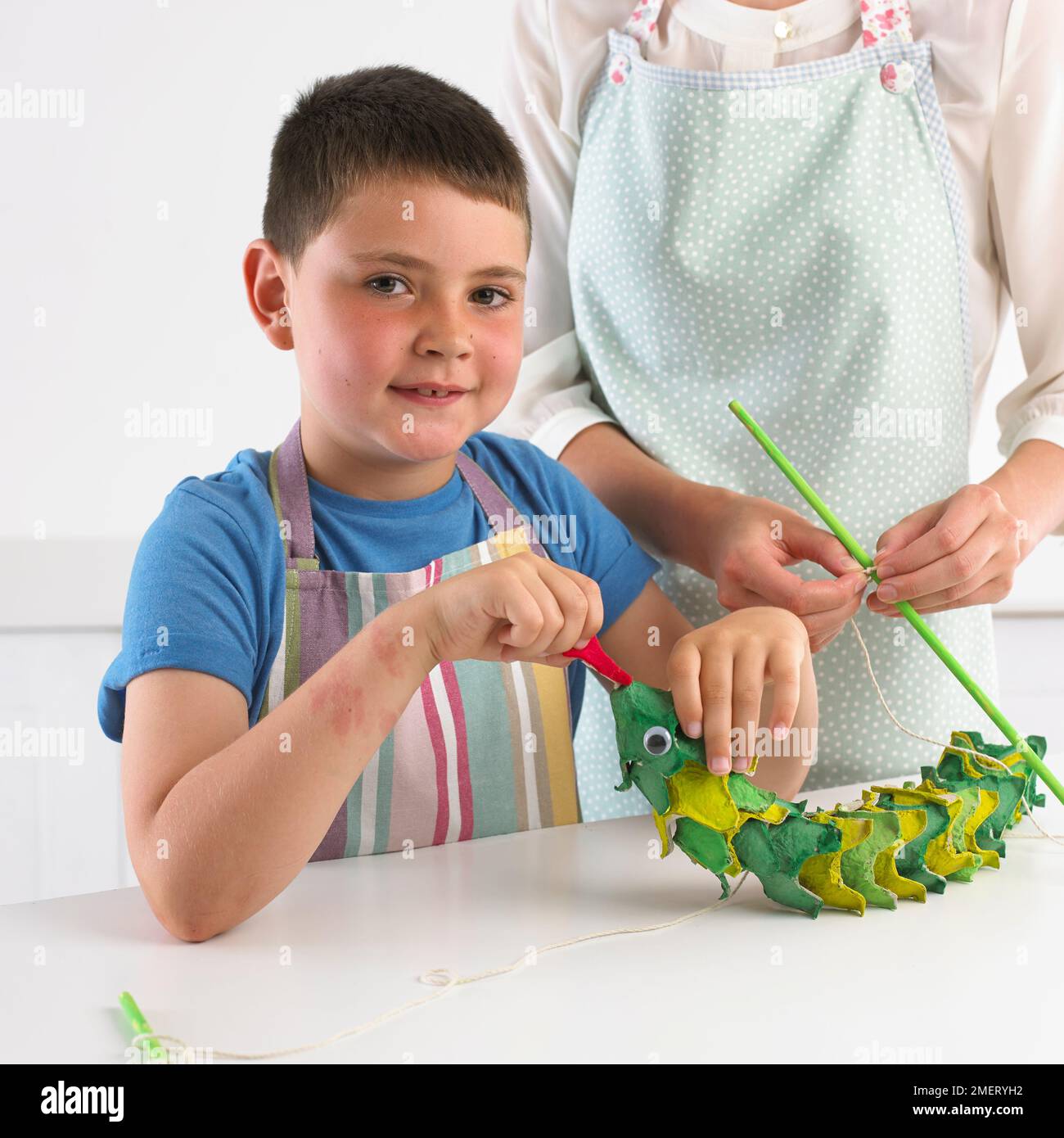 Boy making a puppet from egg boxes, 7 years Stock Photo - Alamy