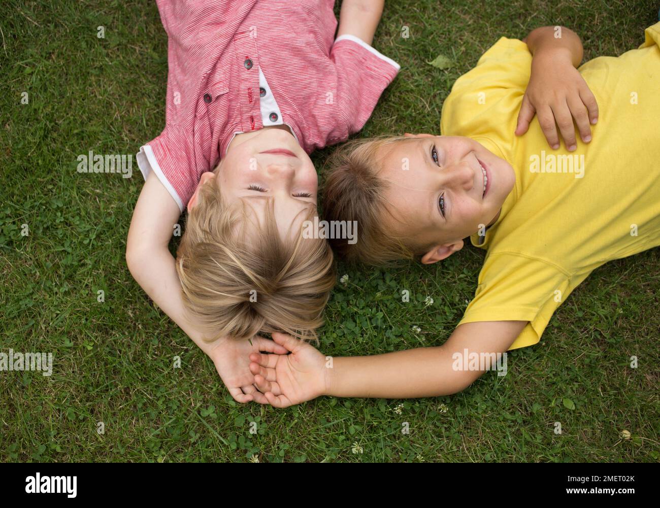 children - preschoolers, boys are tired of playing, lie on their backs ...