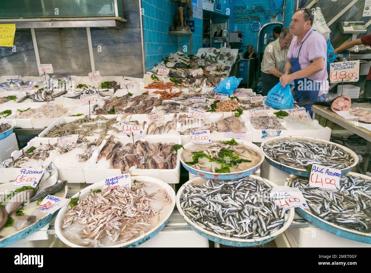 Various types of fresh seafood on display at outdoor fish market in ...