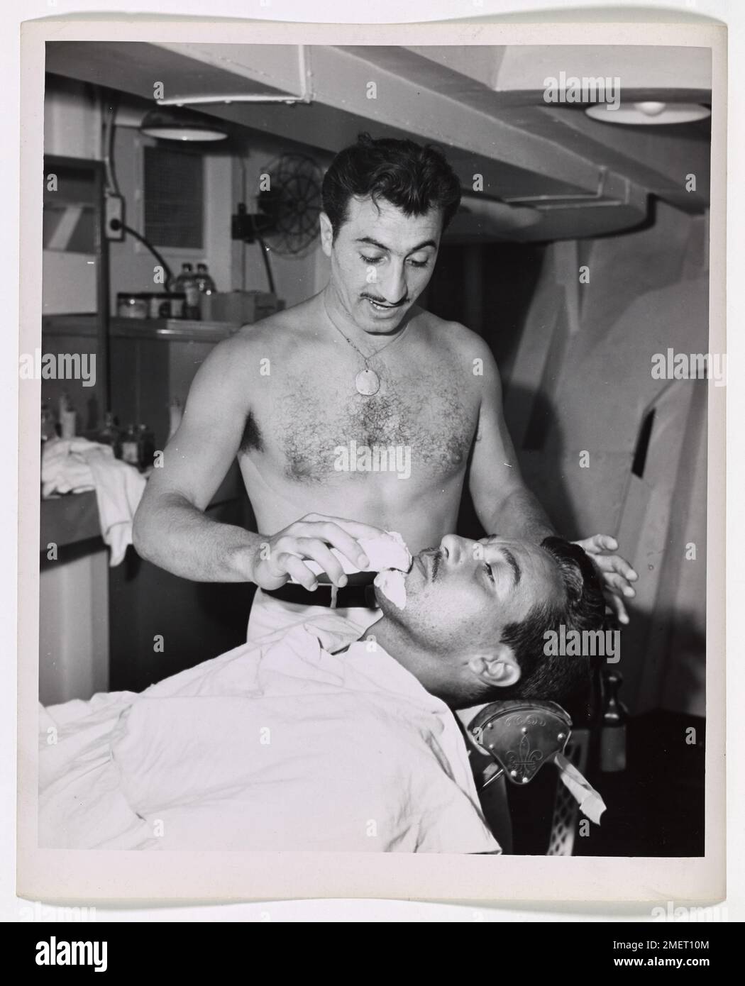 Actor Cesar Romero is pictured in a barbershop, seemingly enjoying some ...