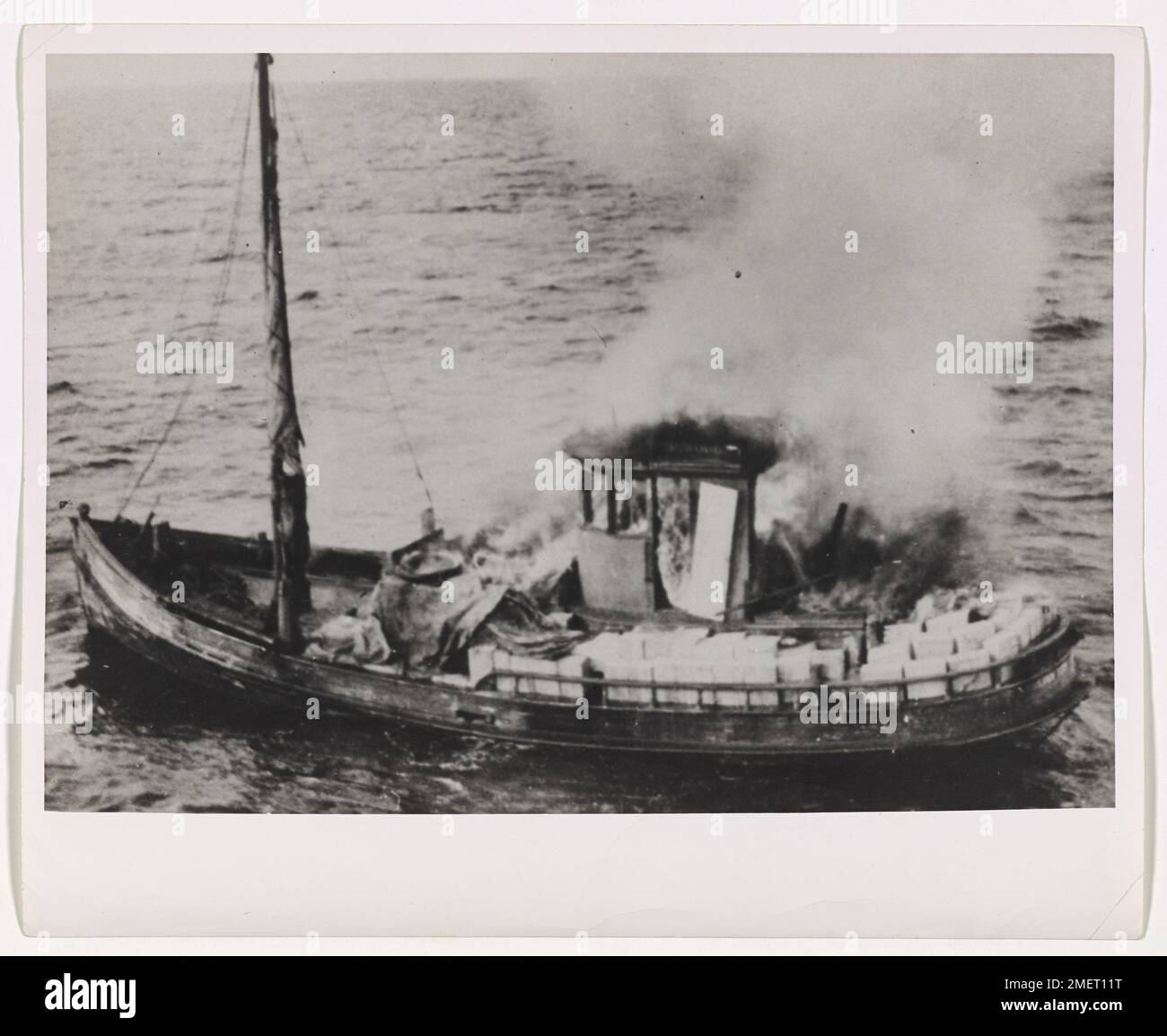 The rum-running vessel LINWOOD is set afire by its crew during a Coast ...