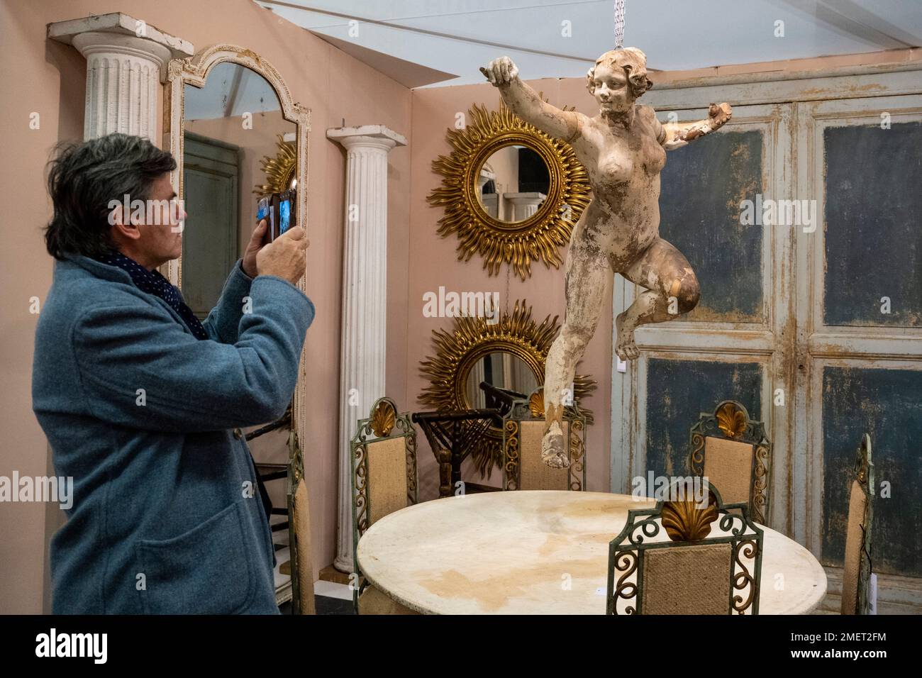 London, UK. 24 January 2023. A visitor photographs a 1920s carved ...