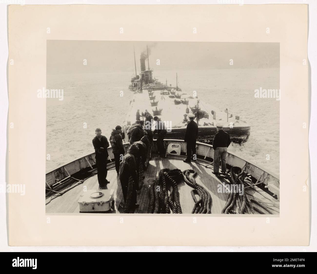 A Coast Guard cutter and a commercially owned tug combine their forces ...