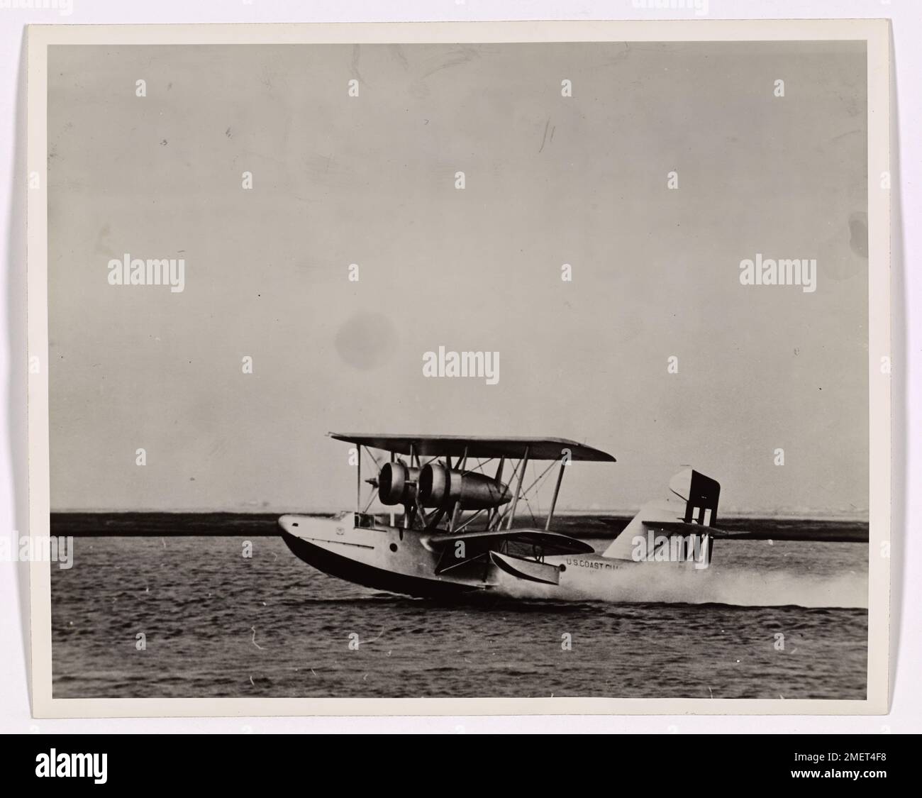 A U.S. Coast Guard plane is shown in the water during a search and ...