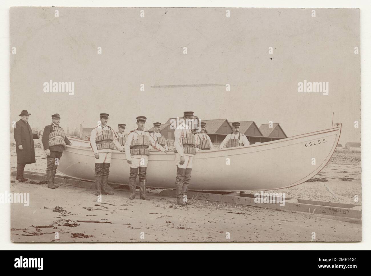 This image shows Coast Guardsmen posing with a small boat at Rye Beach ...
