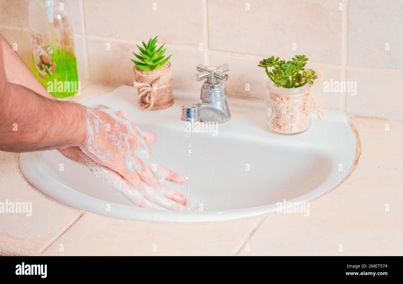 Close up of a person washing their hands with soap, concept of correct ...