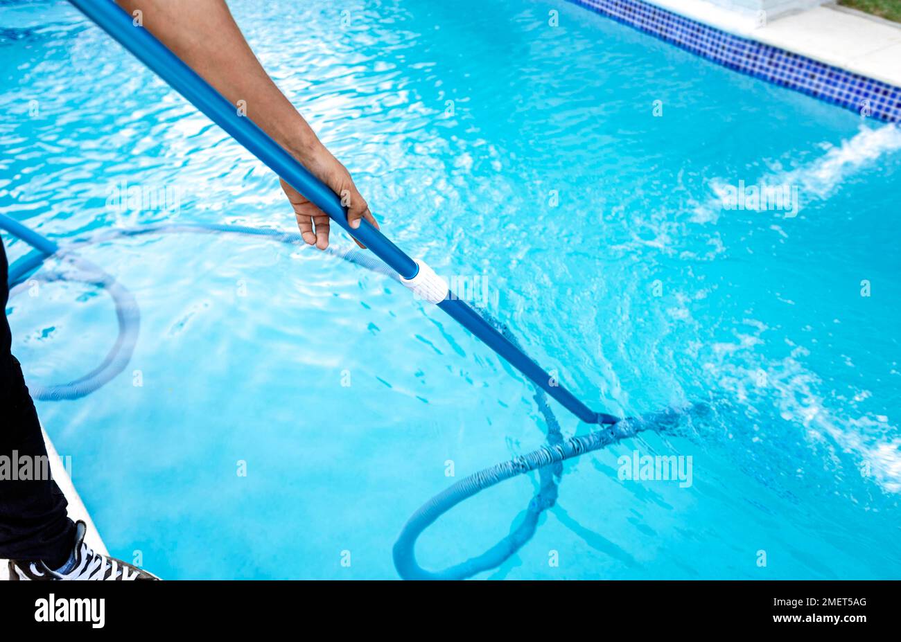 Pool maintenance and cleaning with vacuum hose. People cleaning ...