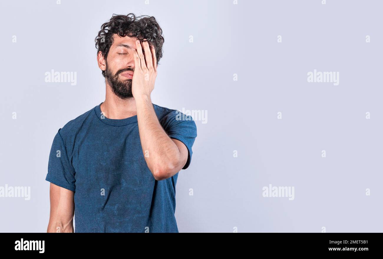 Tired and desperate man covering his face with his hand palm, Concept ...