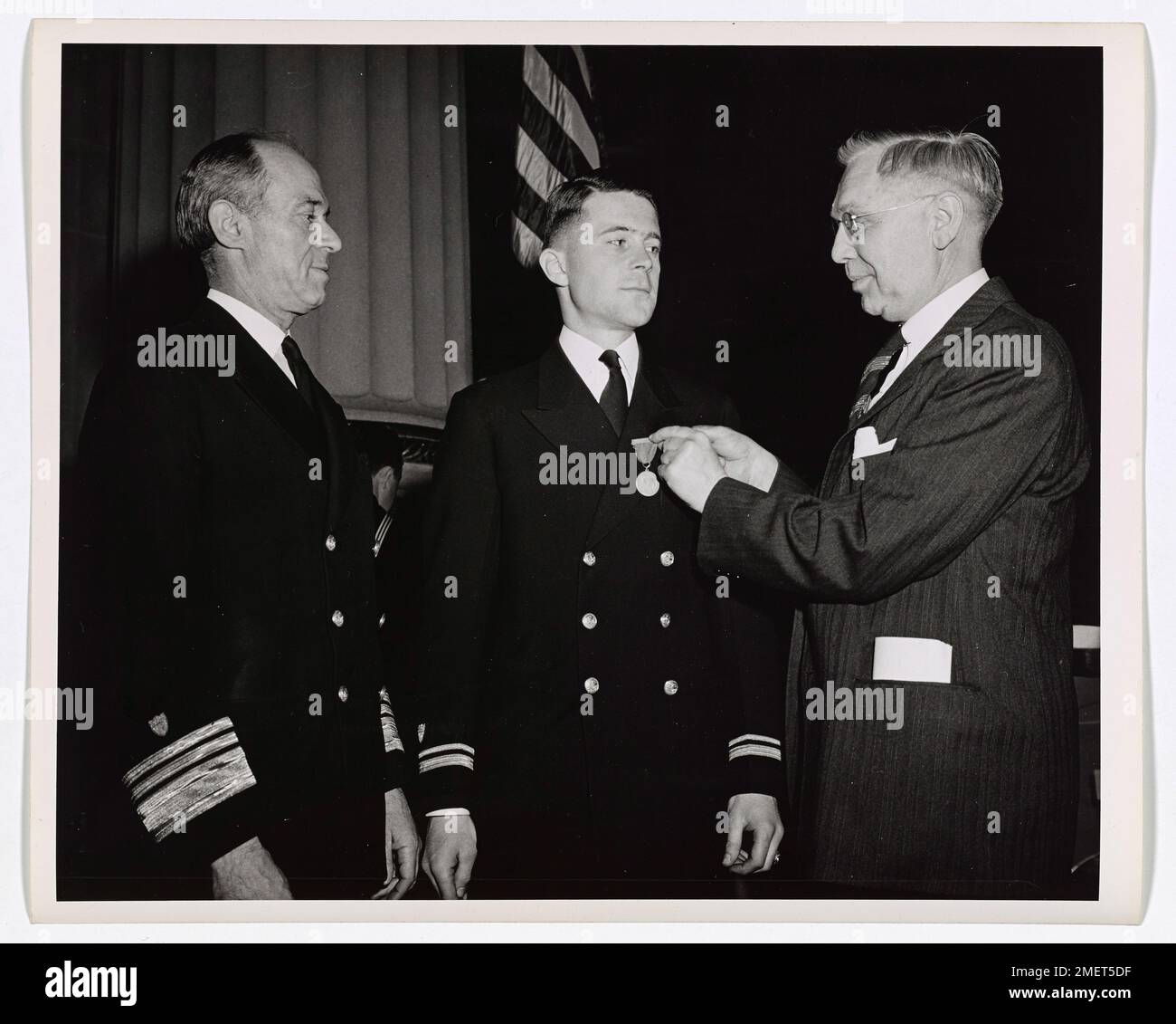 Lieutenant (j.g.) Harry Keene of the U.S. Coast Guard is awarded a gold ...