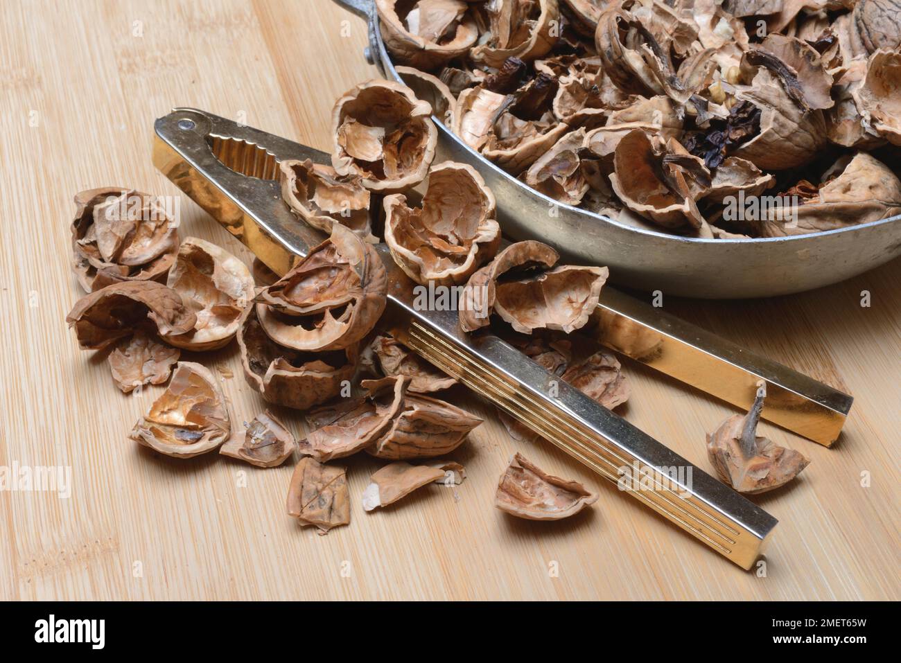 Persian walnut (Juglans regia), walnut shells with nutcracker Stock ...