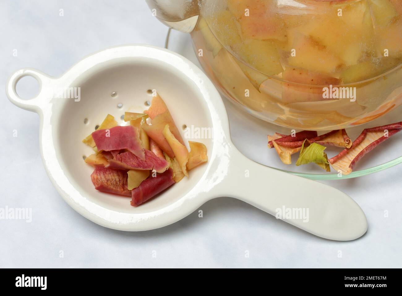 Apple peel tea in teapot and apple peel in tea strainer, apple Stock ...