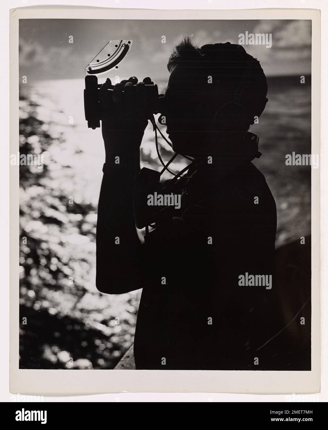 A Coast Guard lookout, silhouetted against the dawn sky over Saipan ...