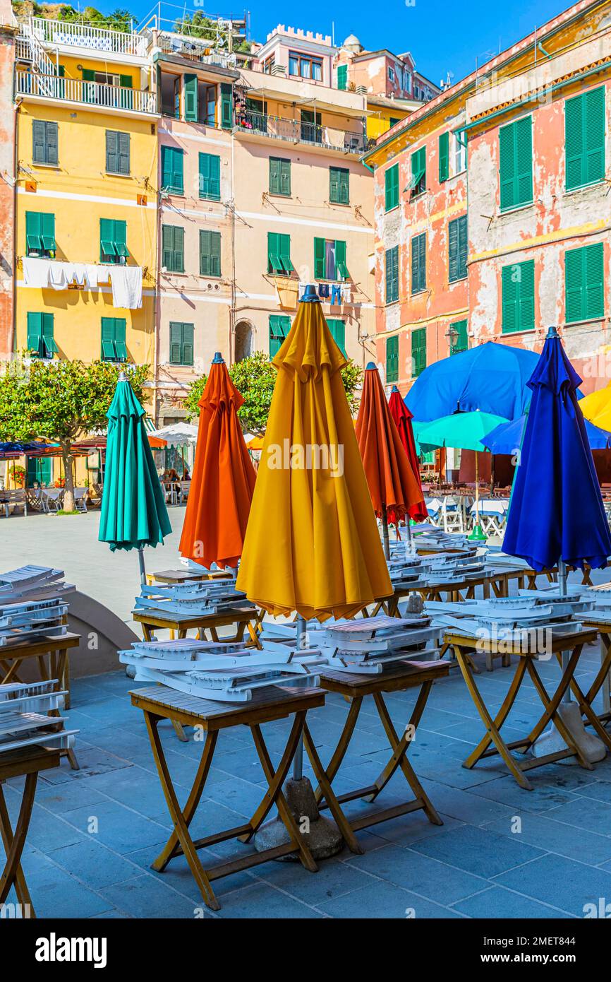 Coloured parasols of a closed restaurant at the main square of Vernazza ...