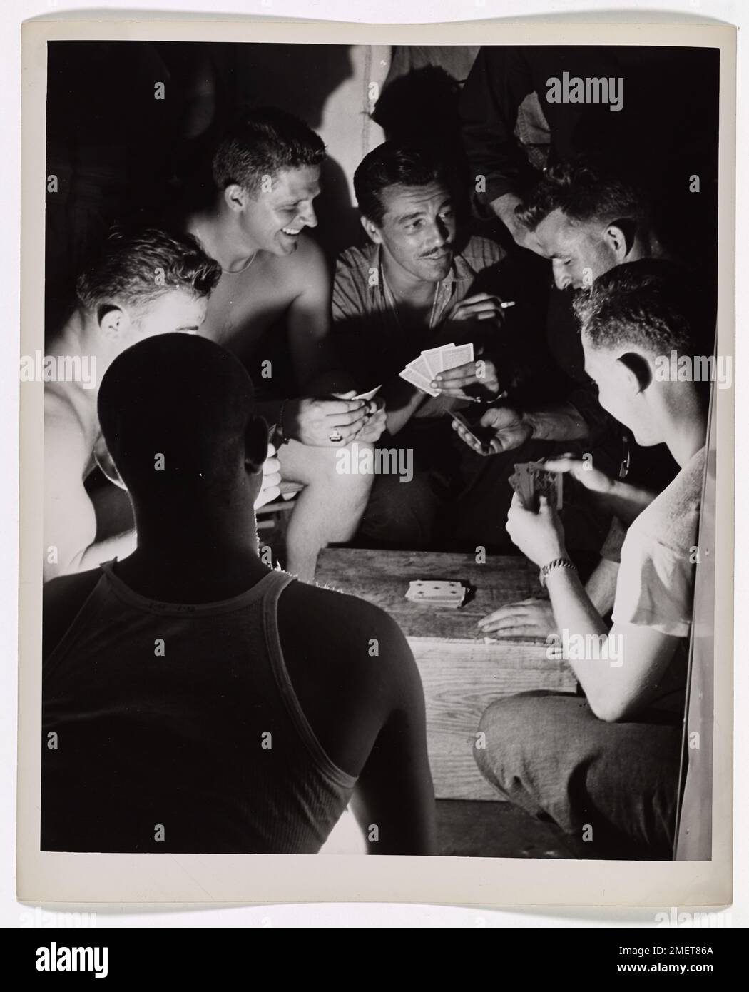 Actor Cesar Romero is photographed playing cards with fellow Coast ...