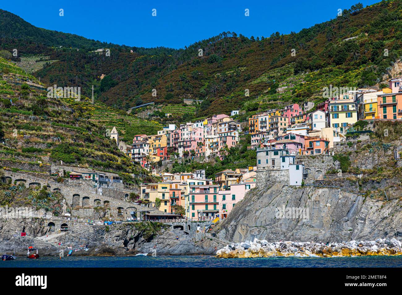 The village of Manarola with its nested pastel-coloured houses built ...