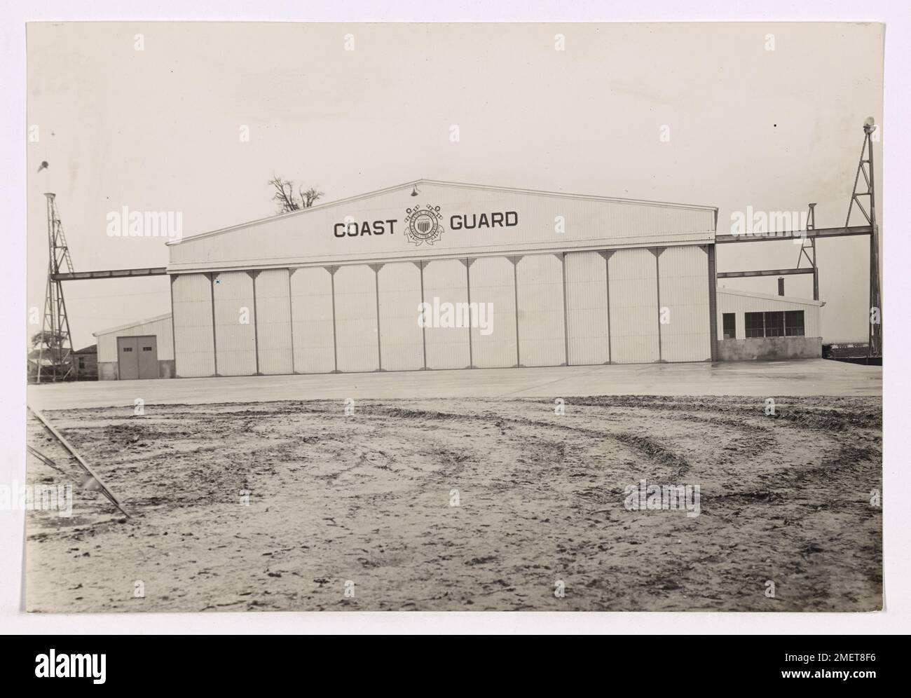 A photograph shows a Coast Guard building, likely located in a coastal ...
