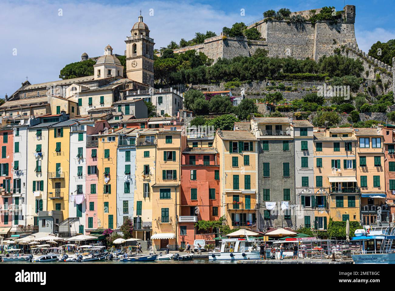 Pastel-coloured house facades in the harbour of Portovenere, behind the ...