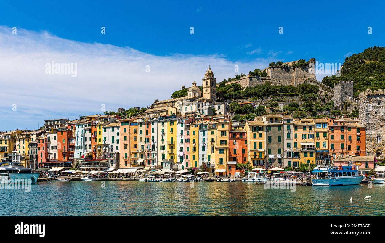 Pastel-coloured house facades in the harbour of Portovenere, behind the ...