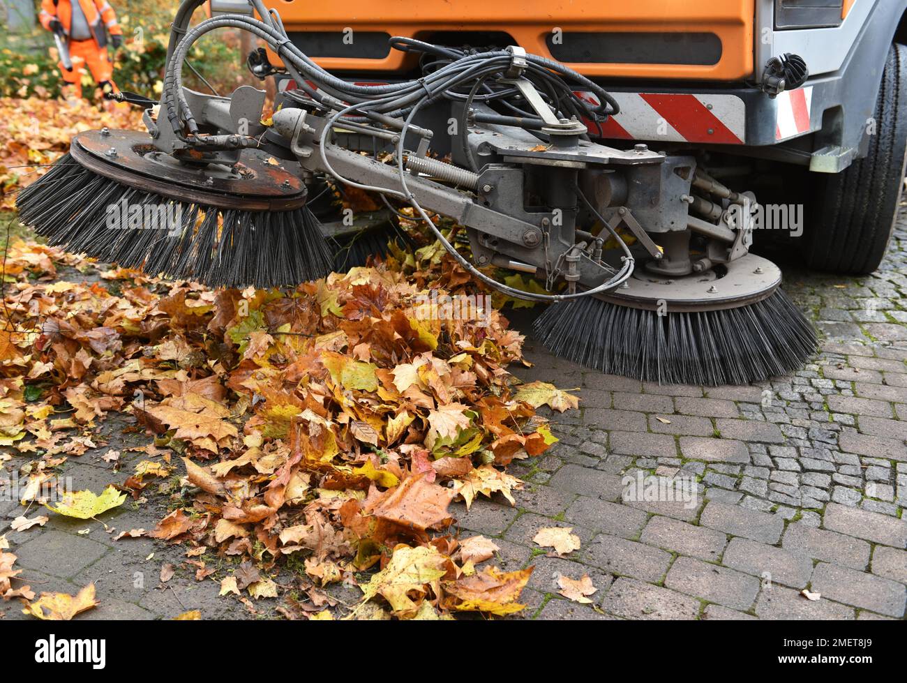 Sweeper sweeps wilted leaves from the road, Vellmar, Hesse, Germany ...