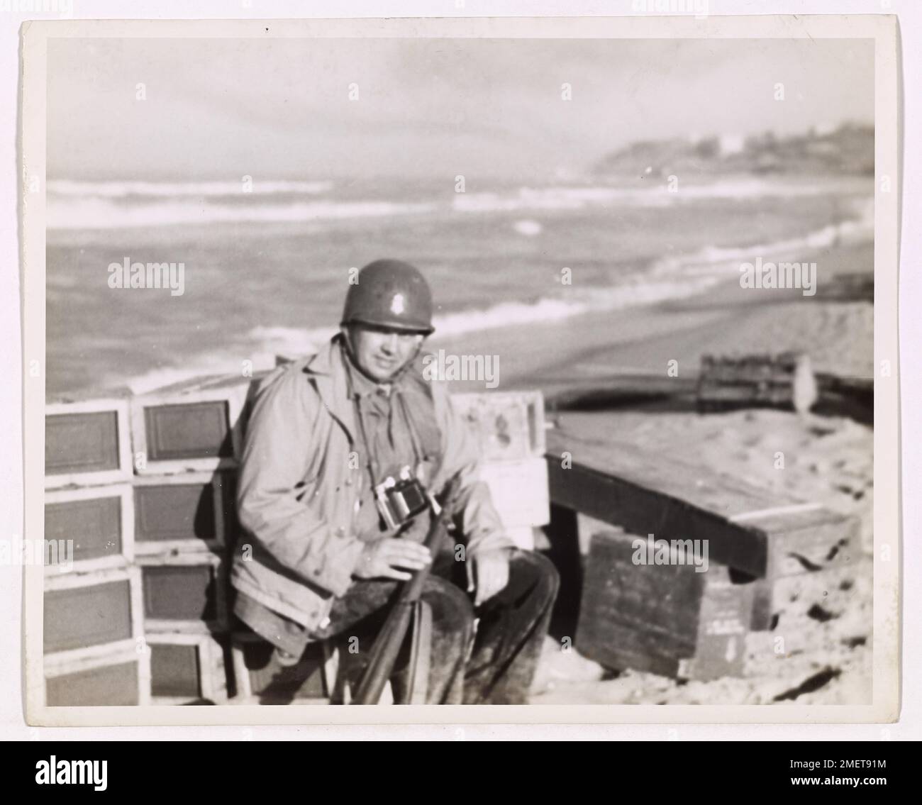 Coast Guard combat photographer William Forsythe takes a brief moment ...