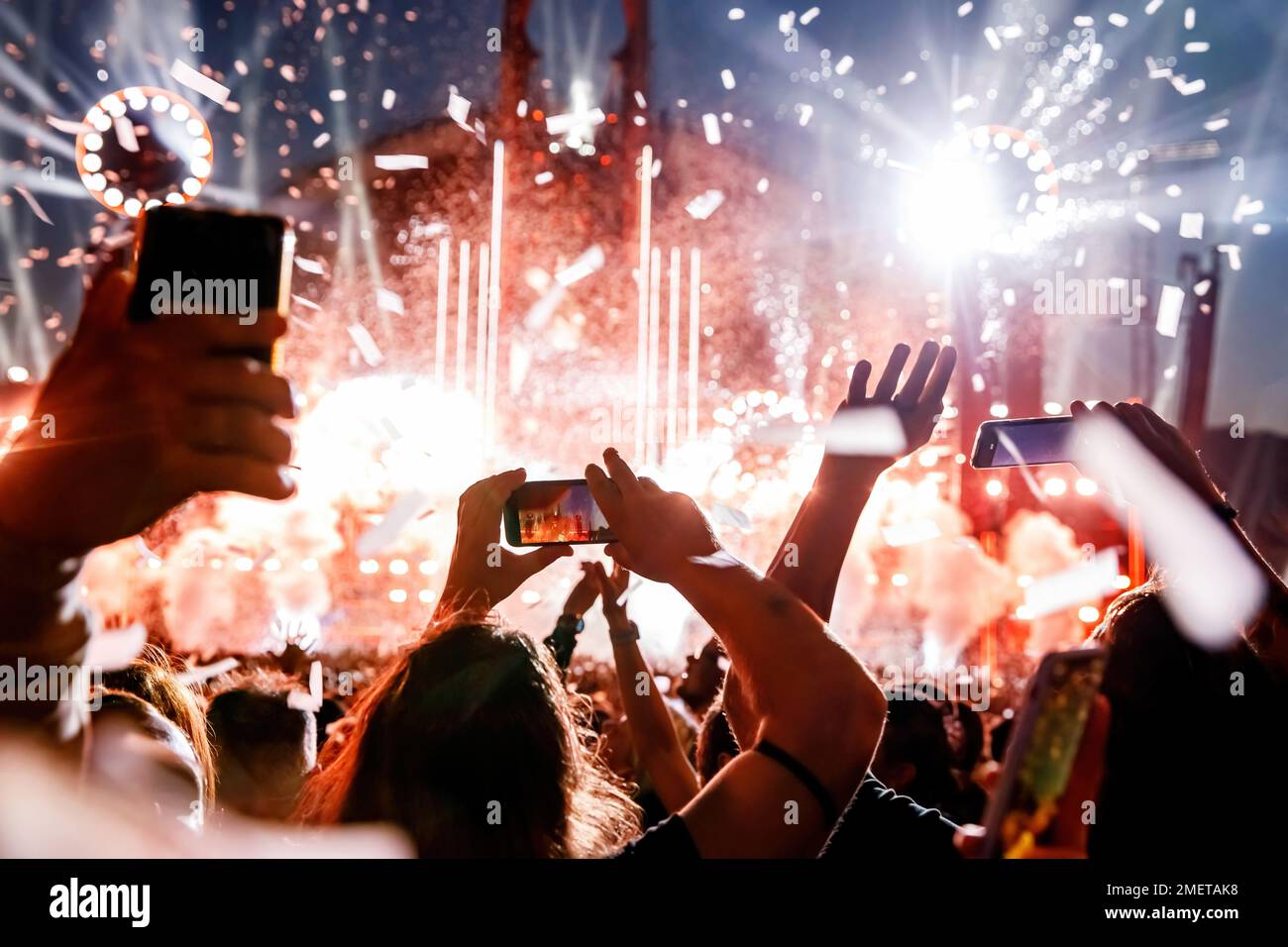 Making video of concert using a smartphone. Cheering people on an ...