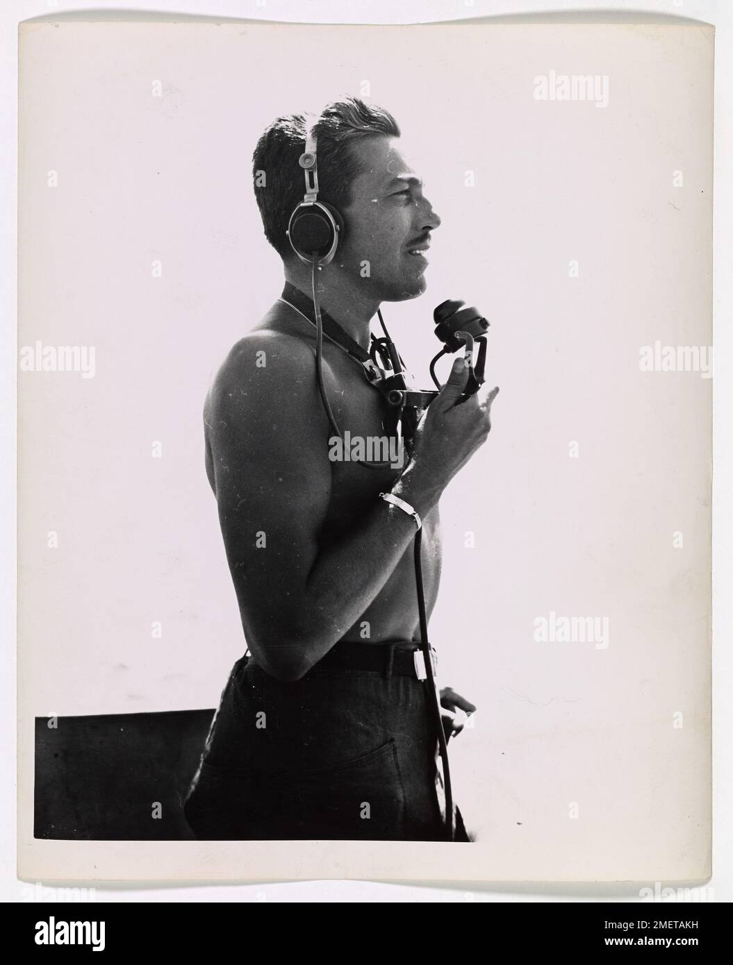 Actor Cesar Romero aboard a Coast Guard-manned transport, using a sound ...
