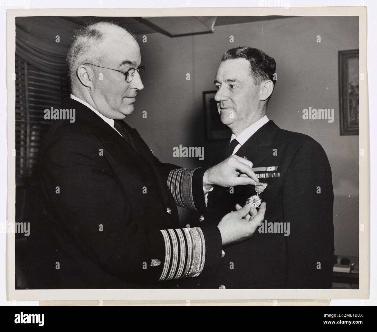This photograph captures Admiral Joseph F. Farley presenting the Legion ...