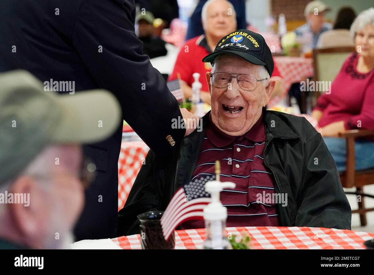 Howard Bennett, a U.S. Army Air Corps veteran, laughs as he speaks with ...