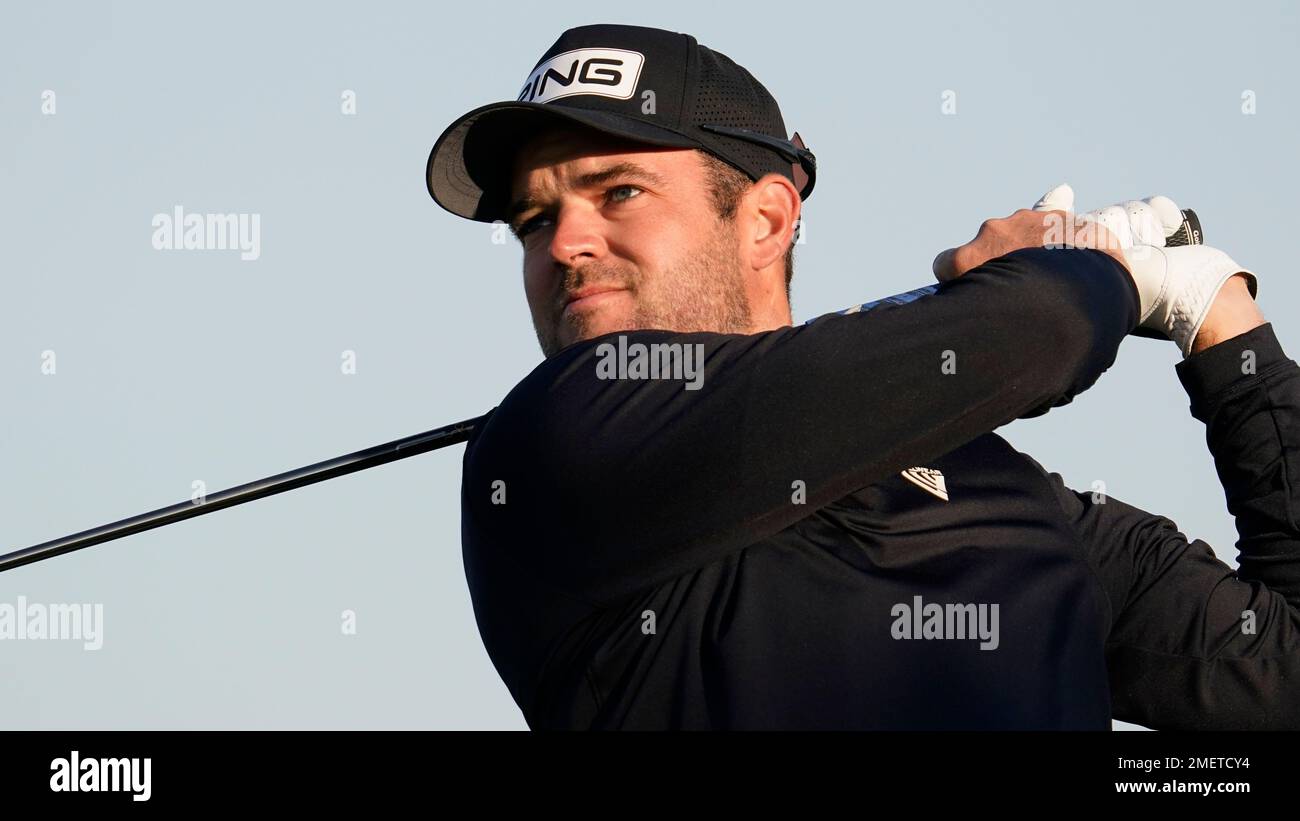 Corey Conners watches his drive on the 11th tee during the first round ...