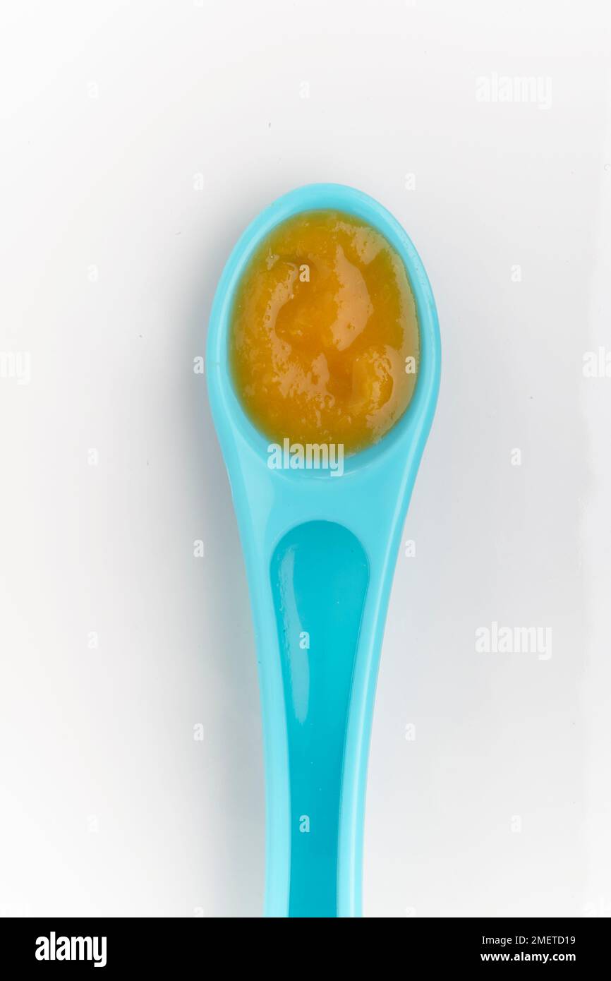 Pureed butternut squash on baby feeding spoon Stock Photo - Alamy