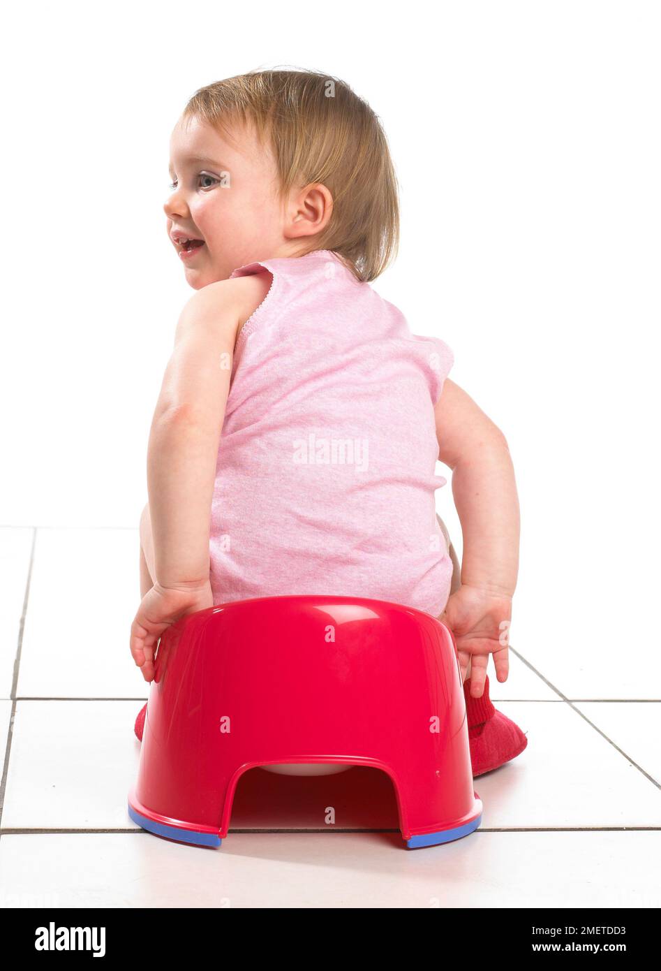 Girl sitting on a red potty, back view, 19 months Stock Photo - Alamy